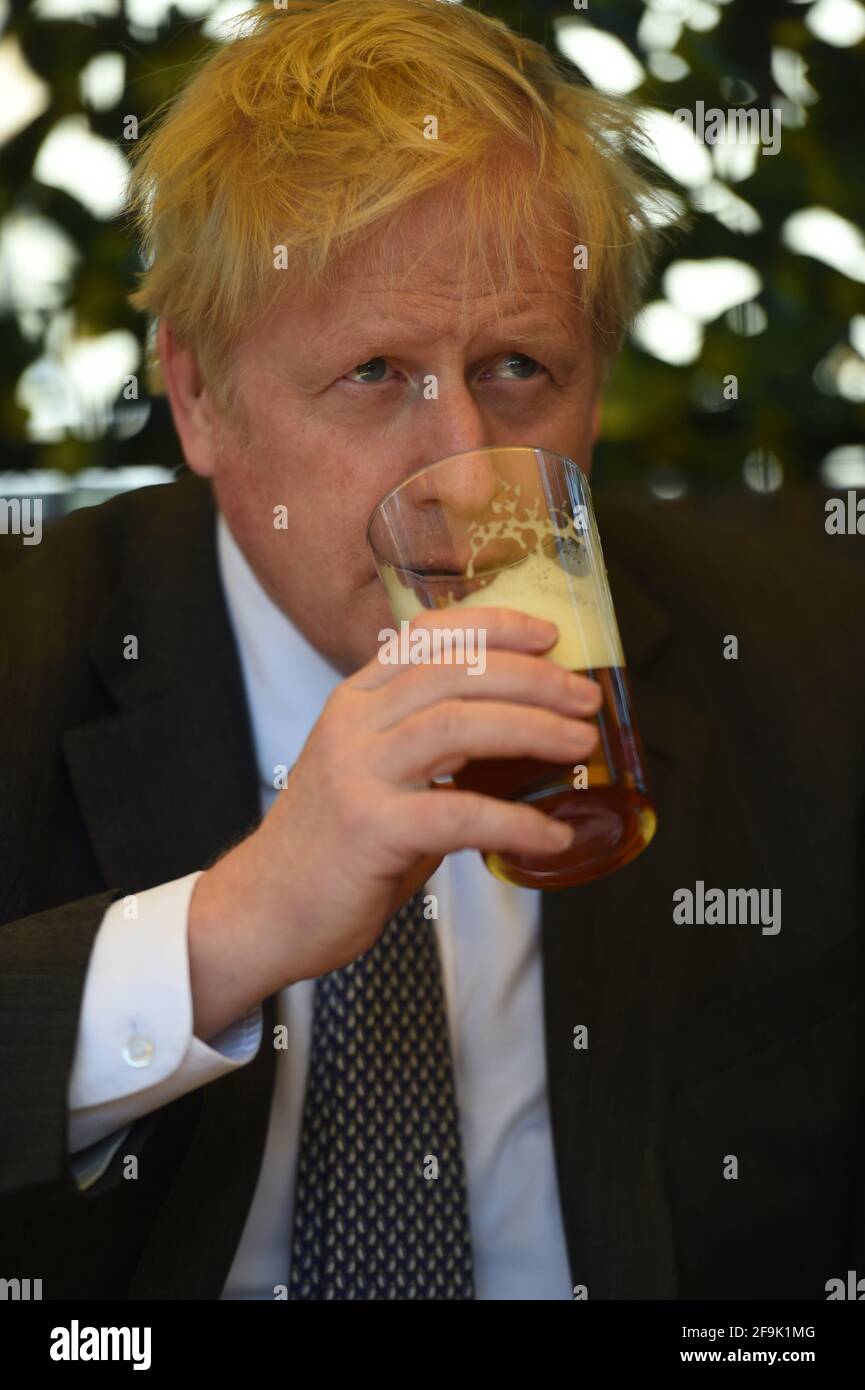 Prime Minister Boris Johnson sips a pint in the beer garden during a ...