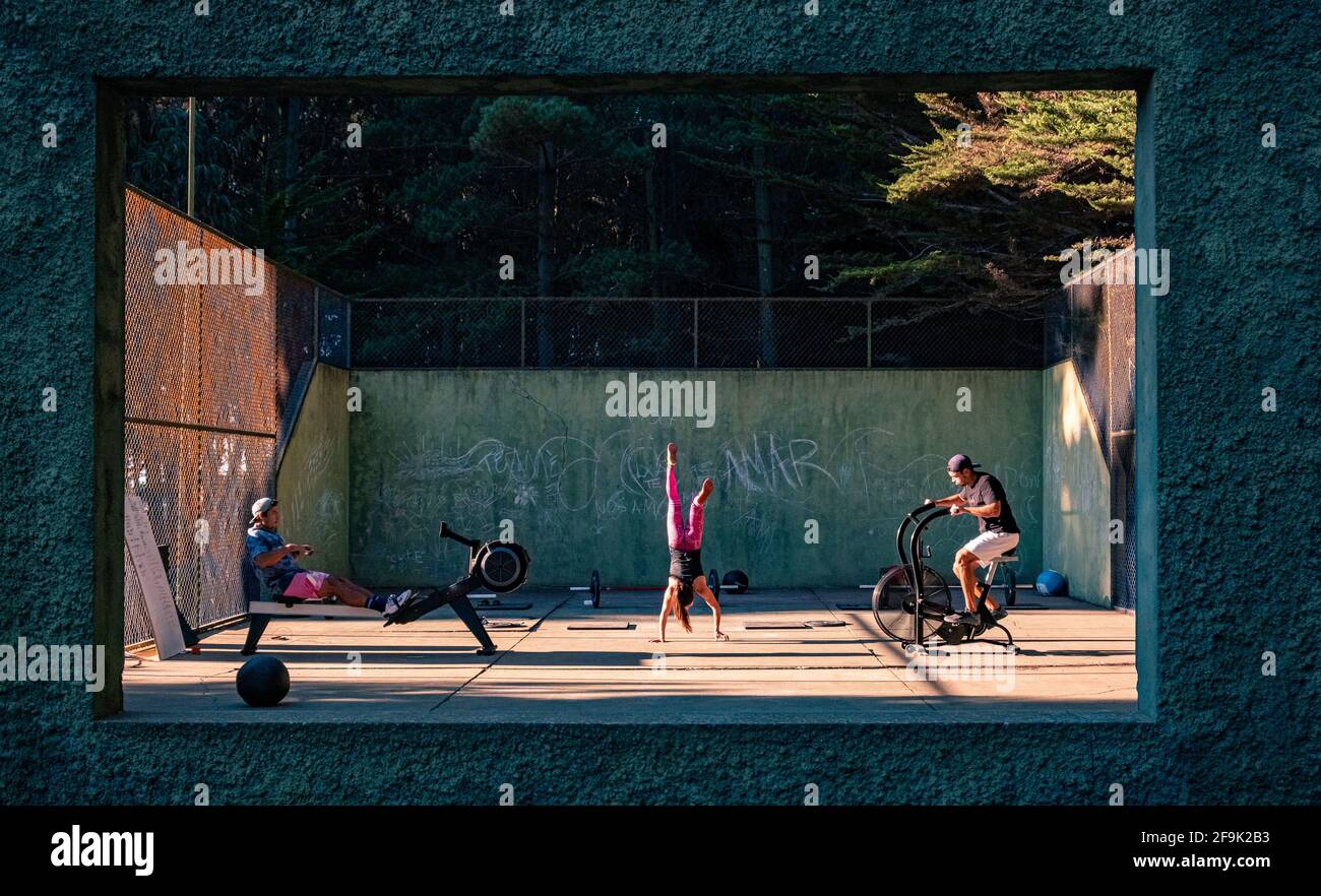 Three friends training outdoors, seeing them through a window frame ...