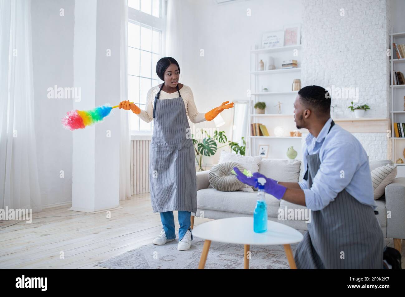 Quarrel over household chores. Angry black man and woman arguing while ...