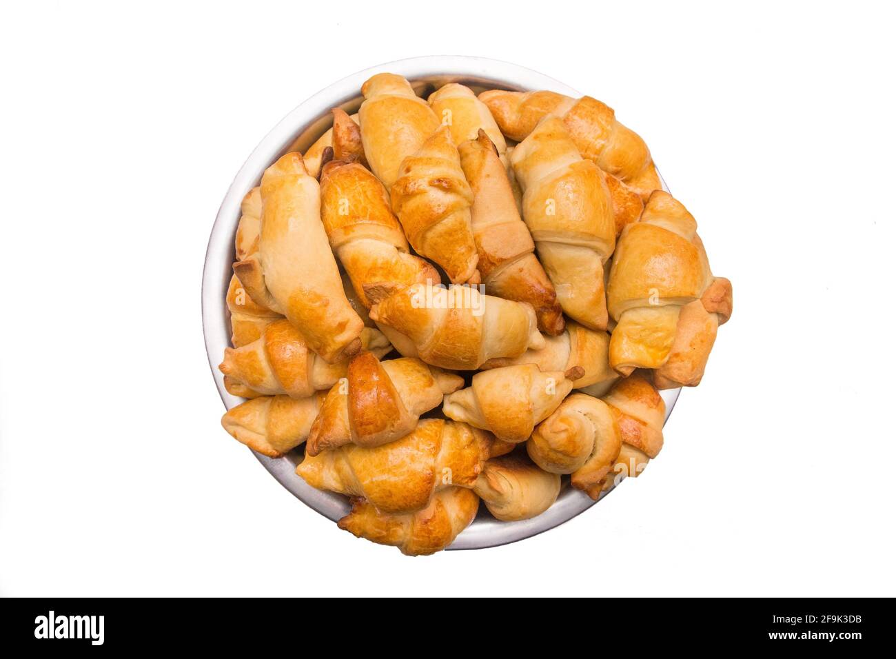 Croissants. Fresh homemade cakes in a heap in a metal dish on a white ...