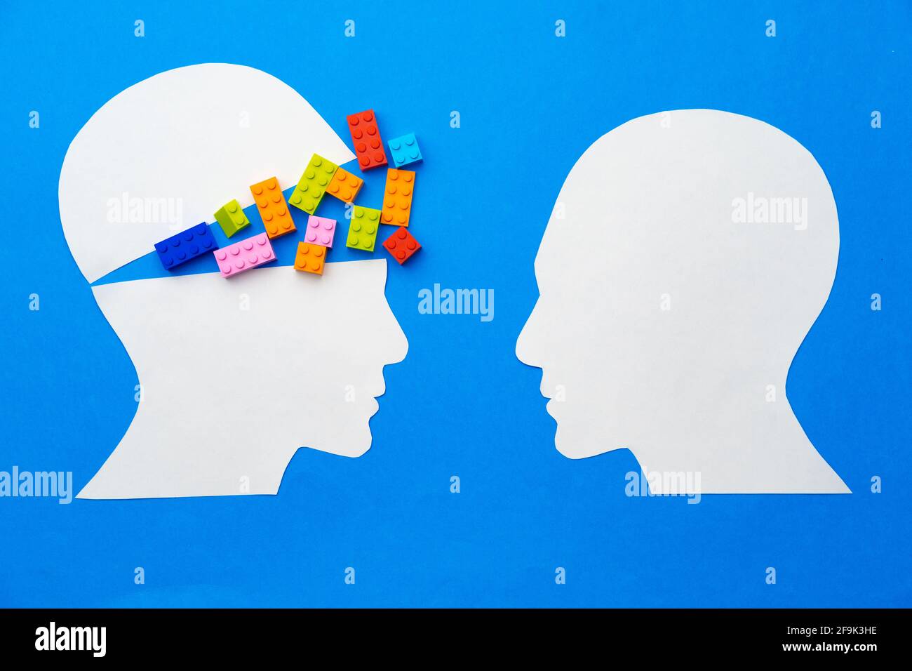 Papercut silhouette of human head with colorful constructor pieces ...