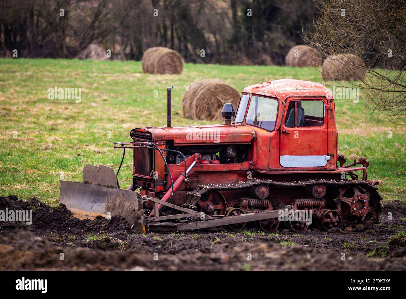 An old caterpillar bulldozer during work on leveling the ground. Made ...