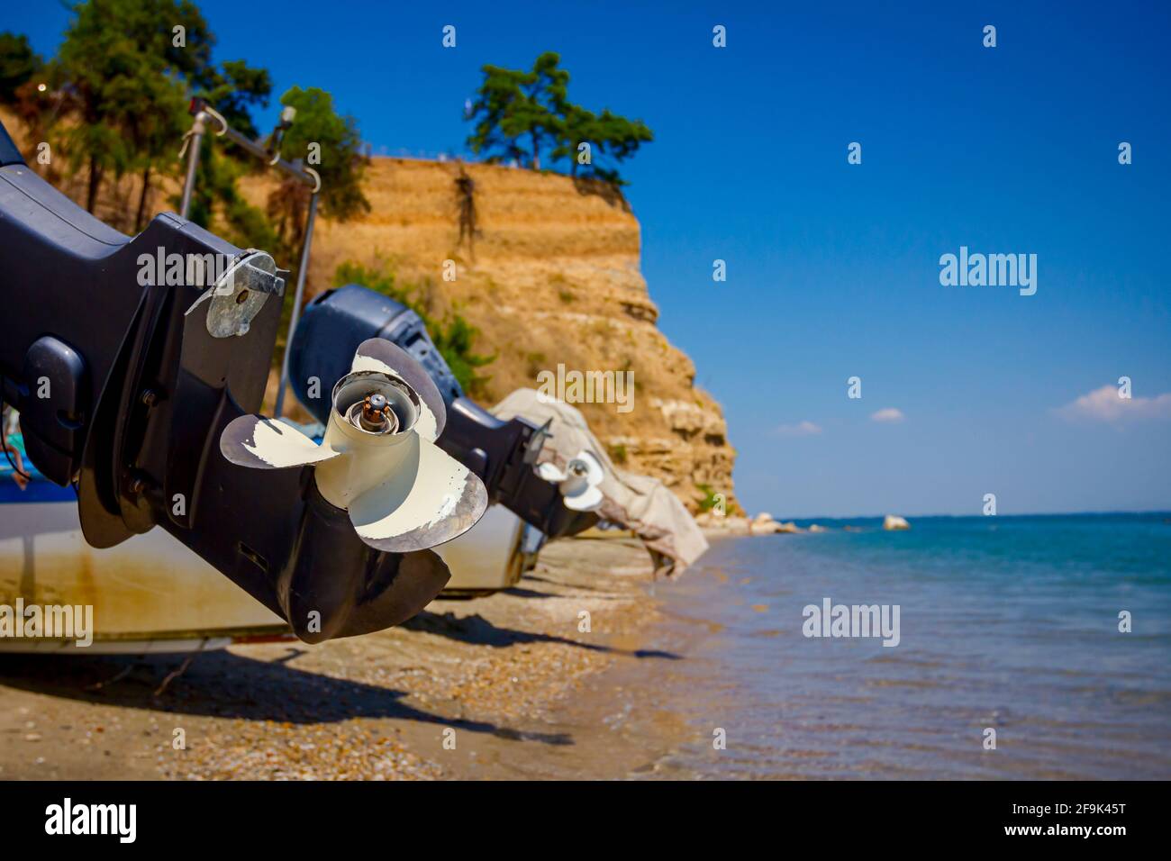View on propeller of motorboat on the sandy beach, foamy waves are ...