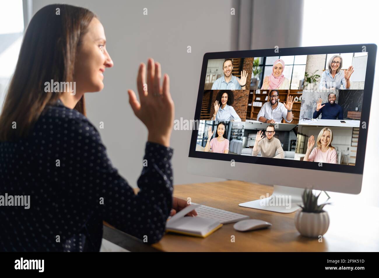 Online video discussion with many people together. Young woman sits in ...