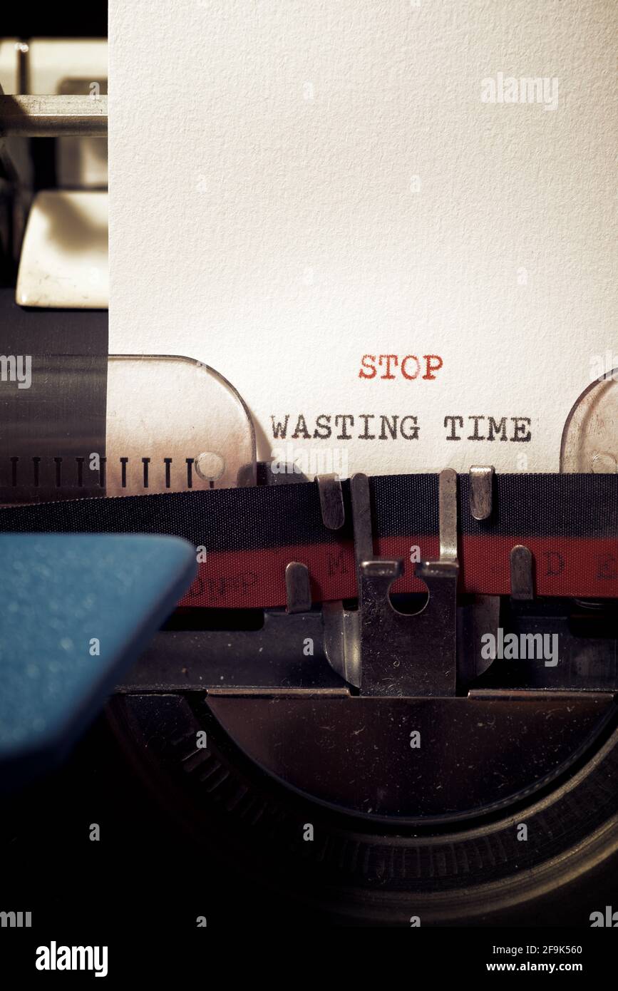 Stop wasting time phrase written with a typewriter Stock Photo - Alamy