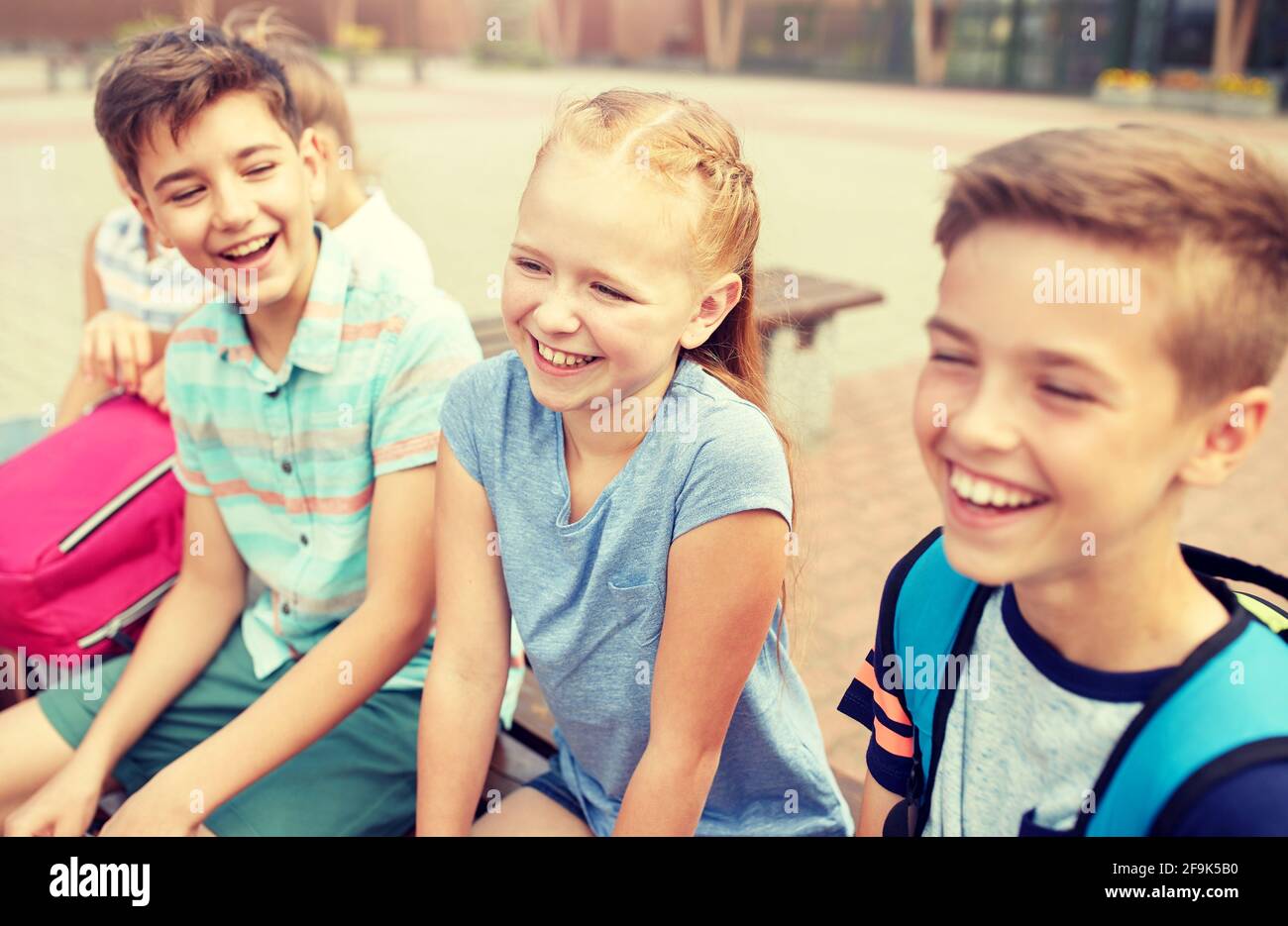 group of happy elementary school students talking Stock Photo - Alamy