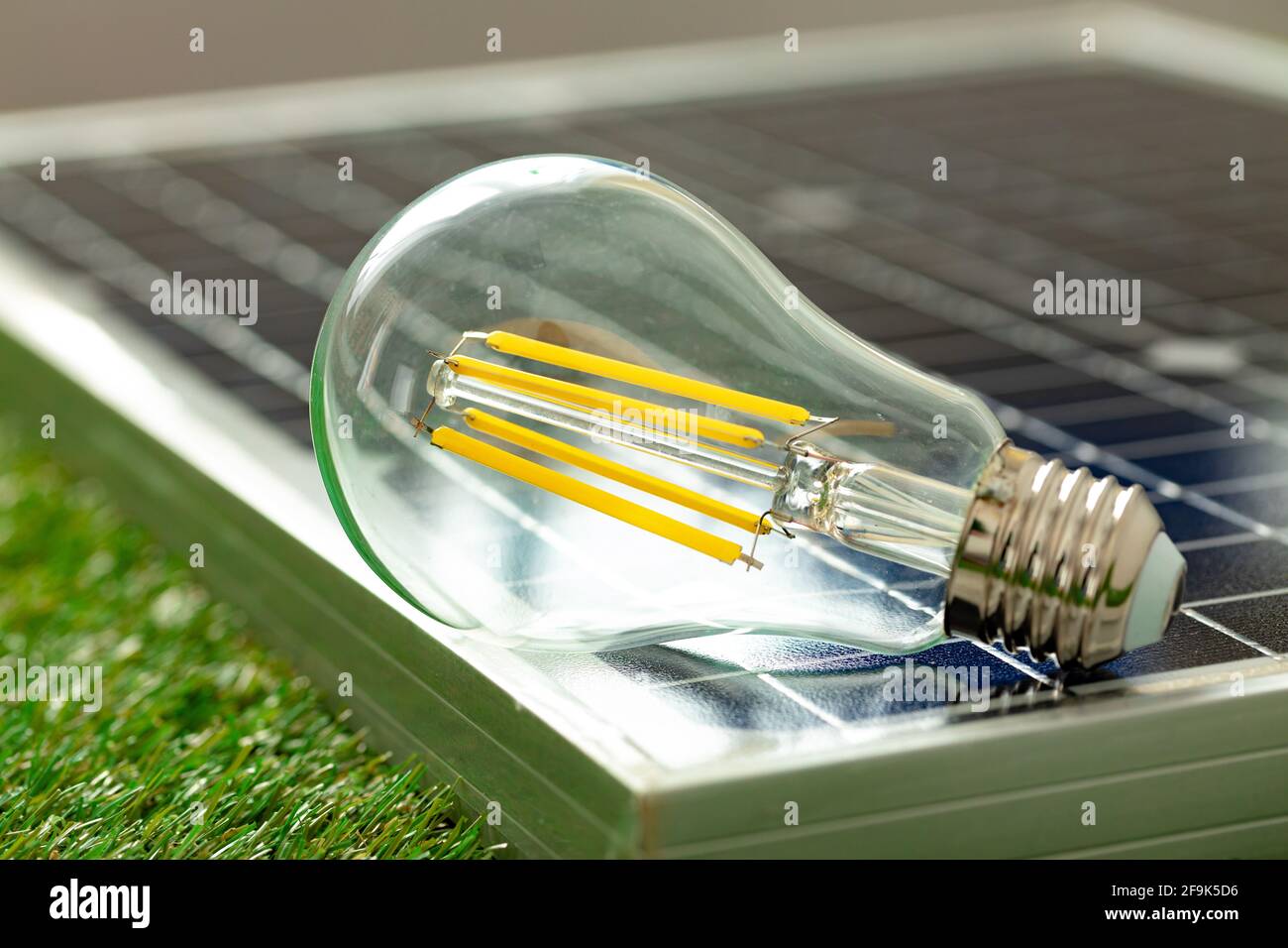 Solar energy panel and light bulb, green energy Stock Photo - Alamy