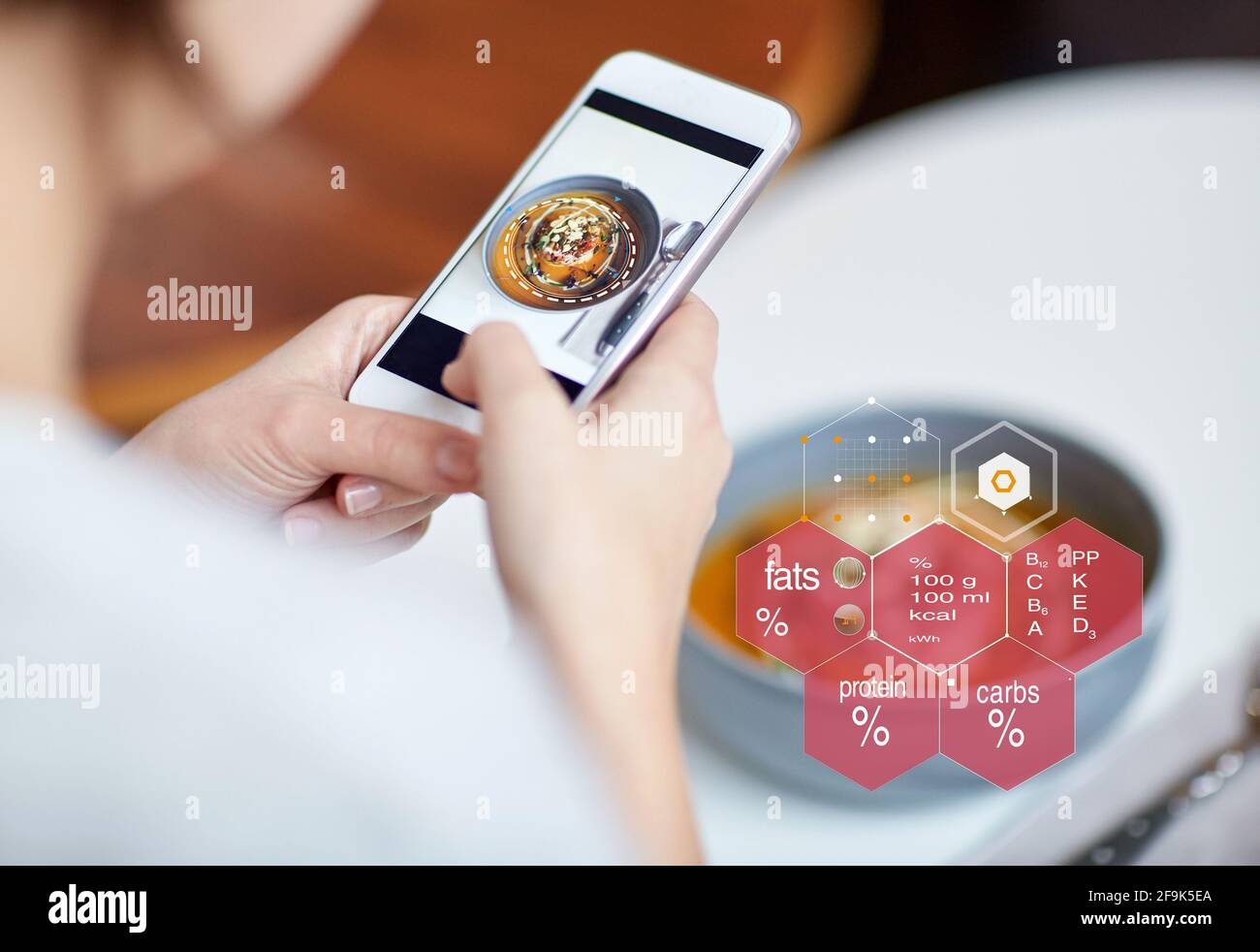 hands with phone and food nutritional value chart Stock Photo - Alamy