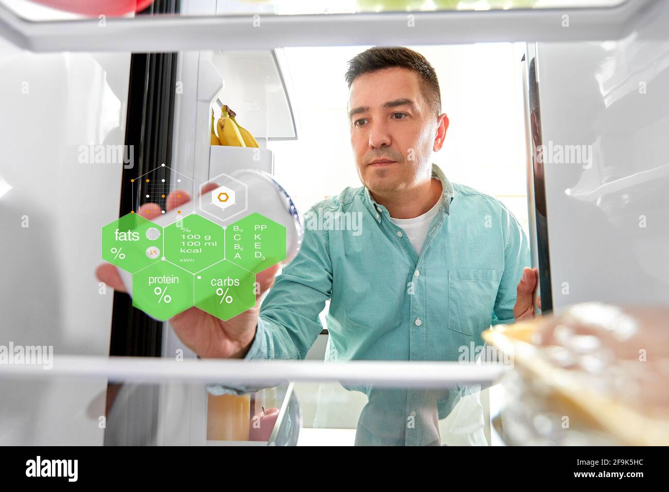 man taking food from fridge at kitchen Stock Photo - Alamy
