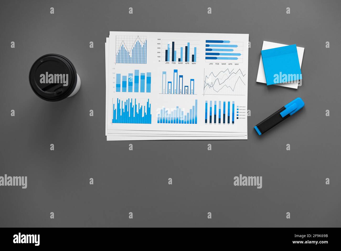 Financial paper with charts and diagrams on gray table Stock Photo - Alamy