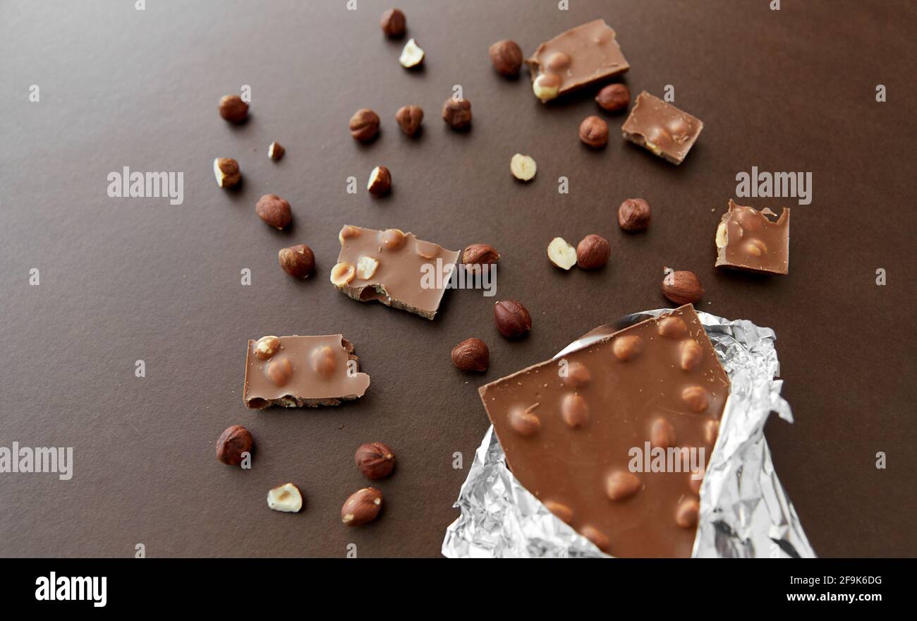 milk chocolate bar with hazelnuts in foil wrapper Stock Photo - Alamy