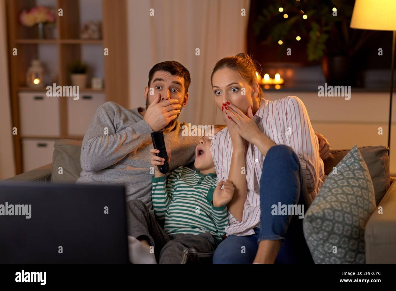 scared family watching tv at home at night Stock Photo - Alamy