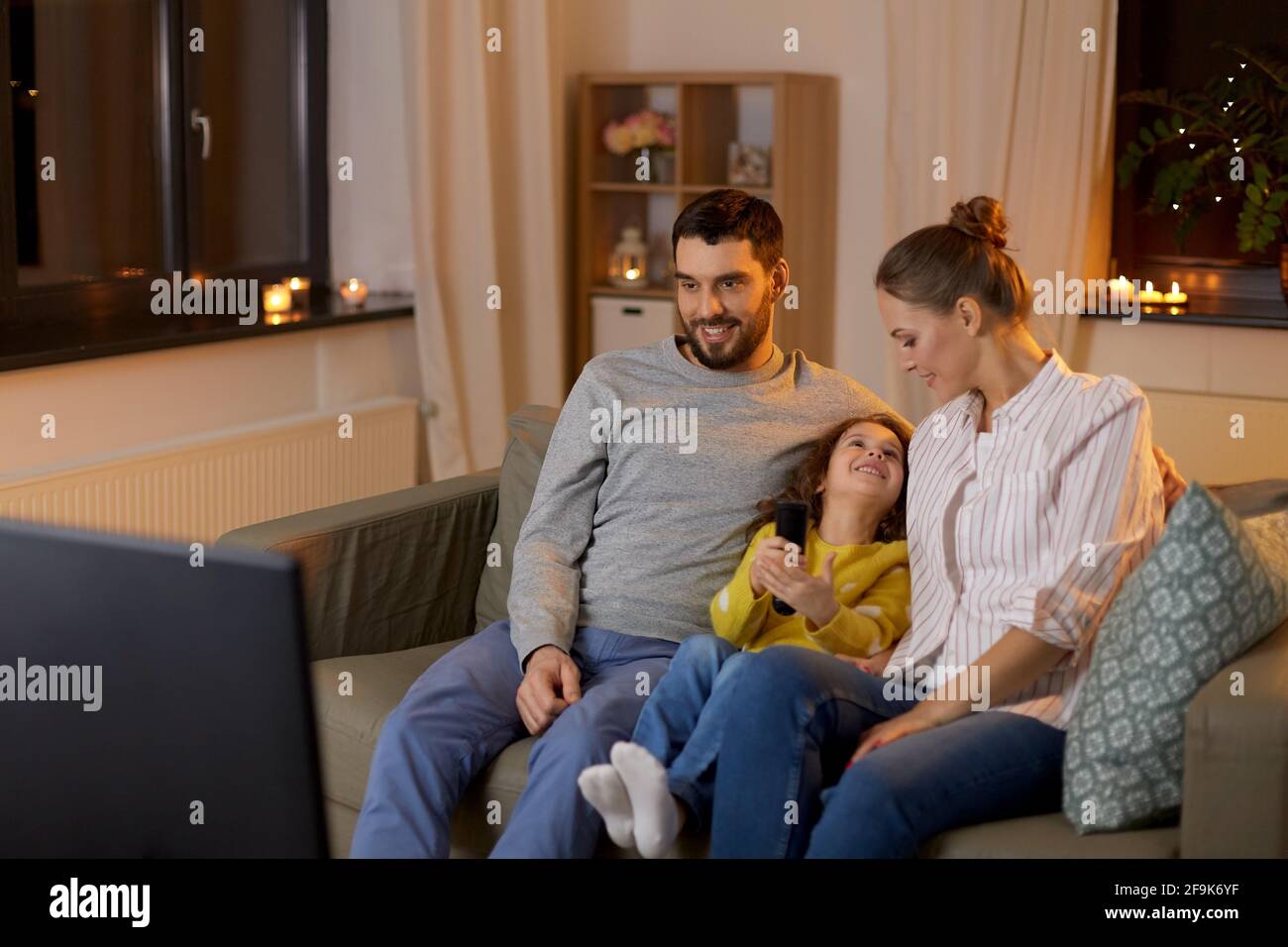 happy family watching tv at home at night Stock Photo - Alamy