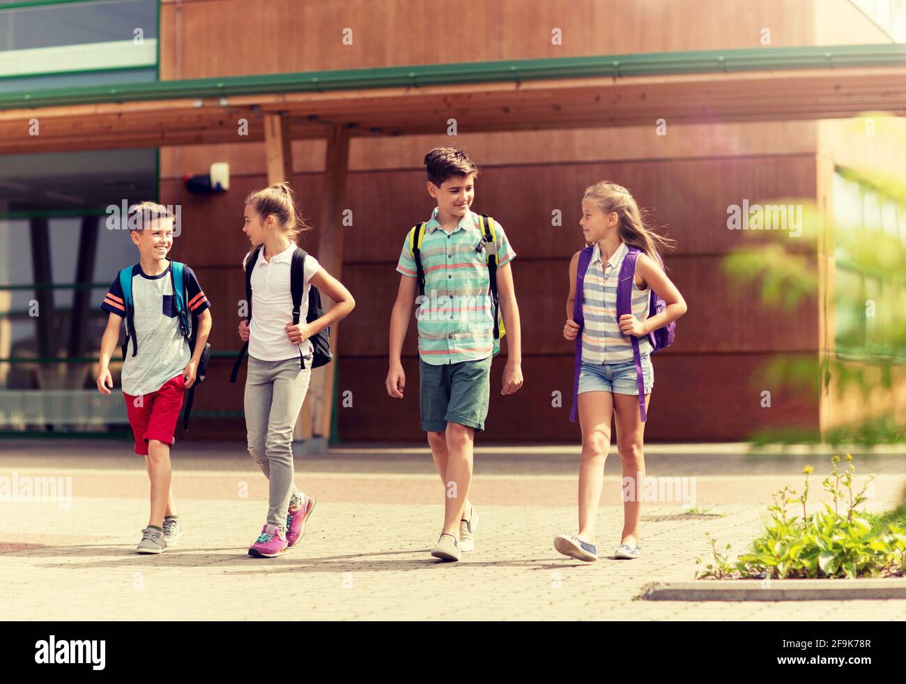 group of happy elementary school students walking Stock Photo - Alamy