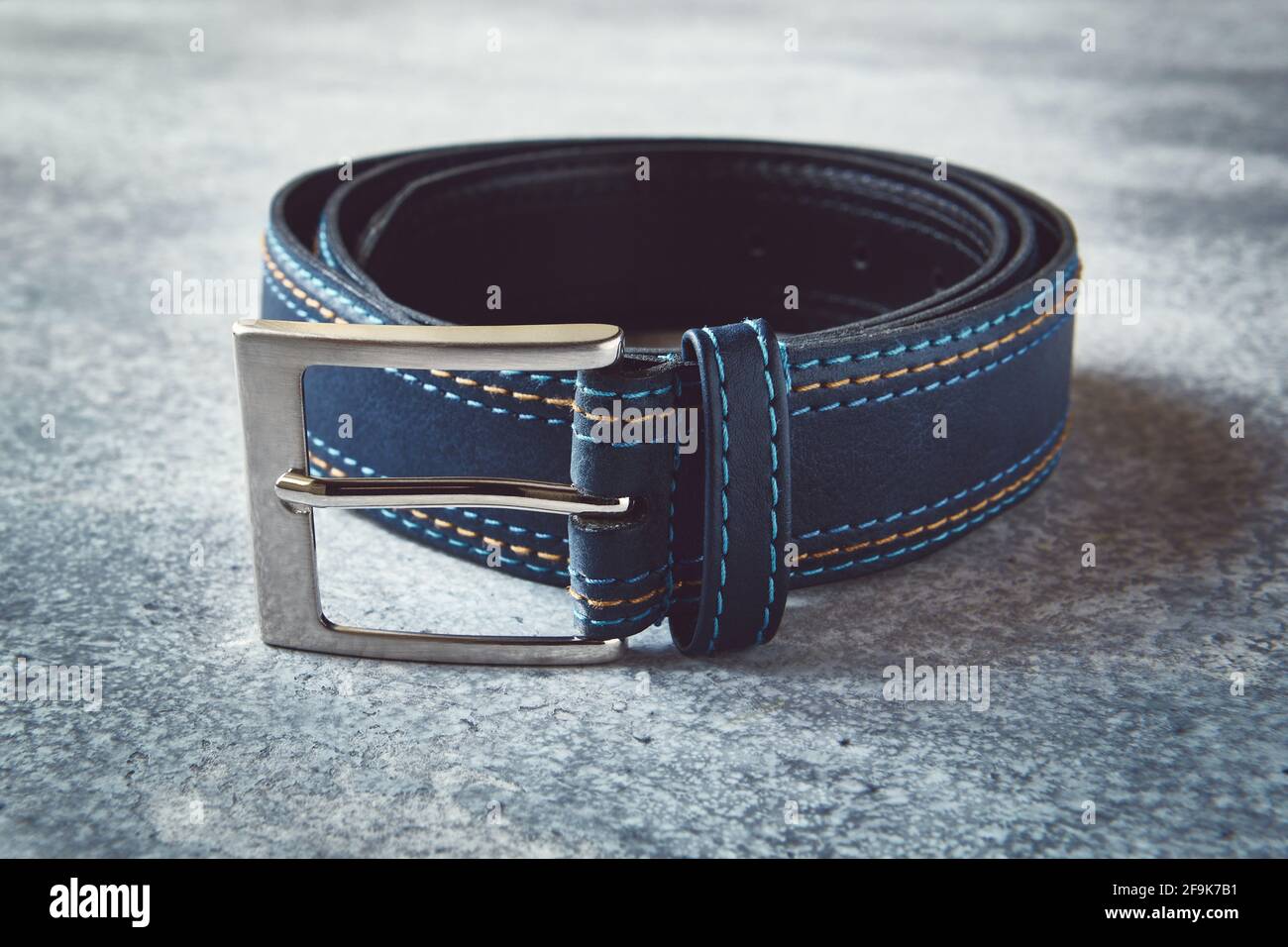 Stylish leather blue belt on gray background, close up, stylized Stock ...