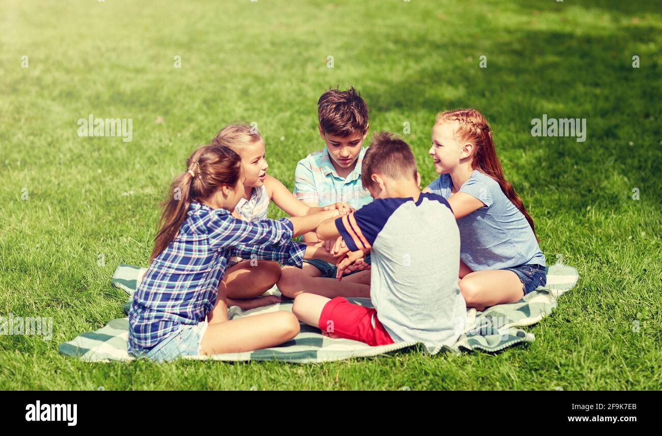 group of happy kids putting hands together Stock Photo - Alamy