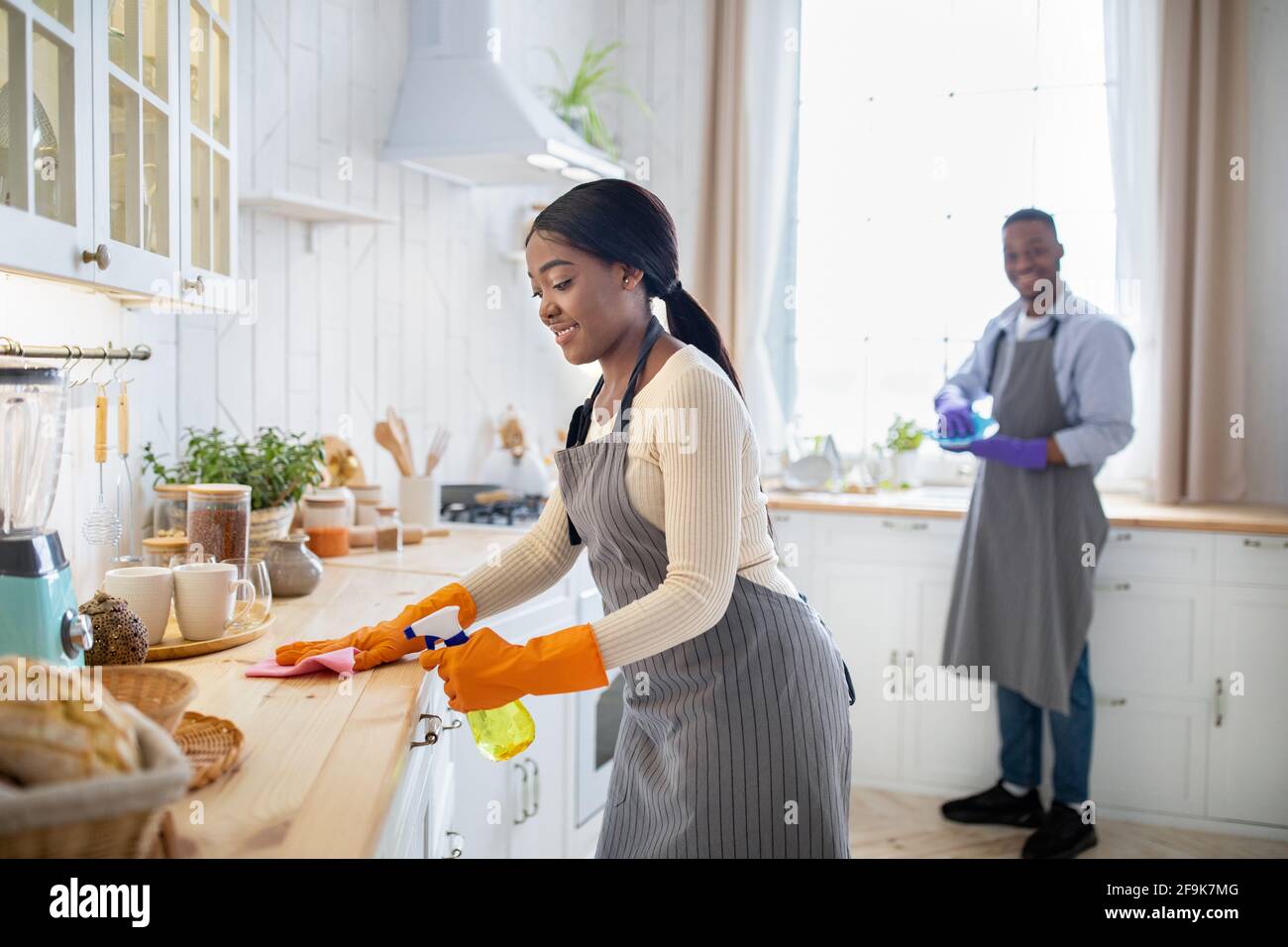 Black woman cleaning kitchen table hi-res stock photography and images ...