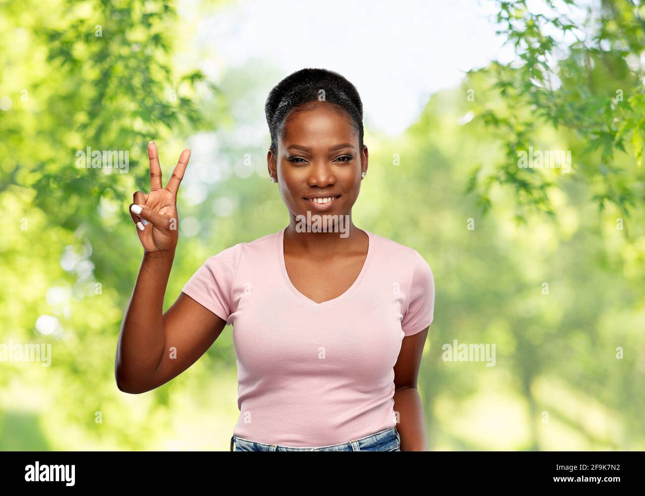 happy african american woman showing peace Stock Photo - Alamy