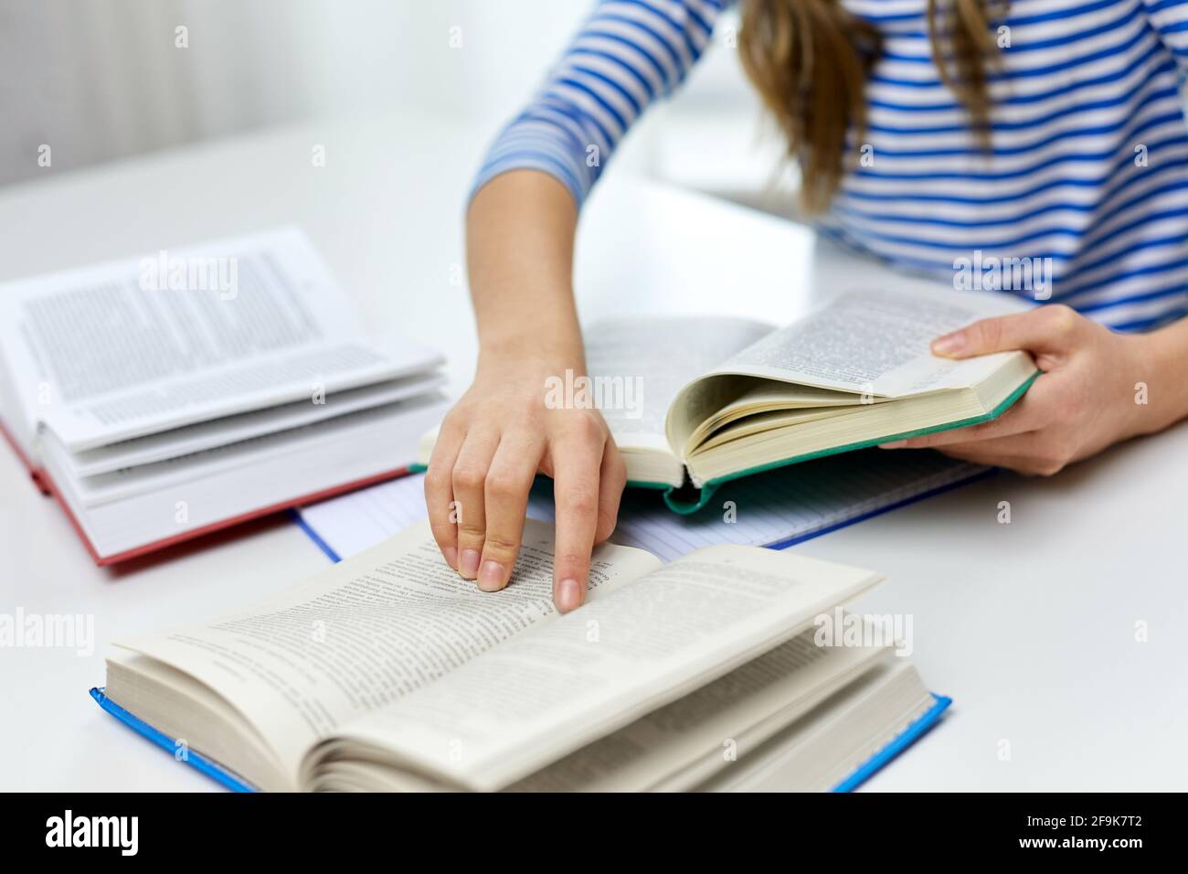 close up of student girl reading books at home Stock Photo - Alamy