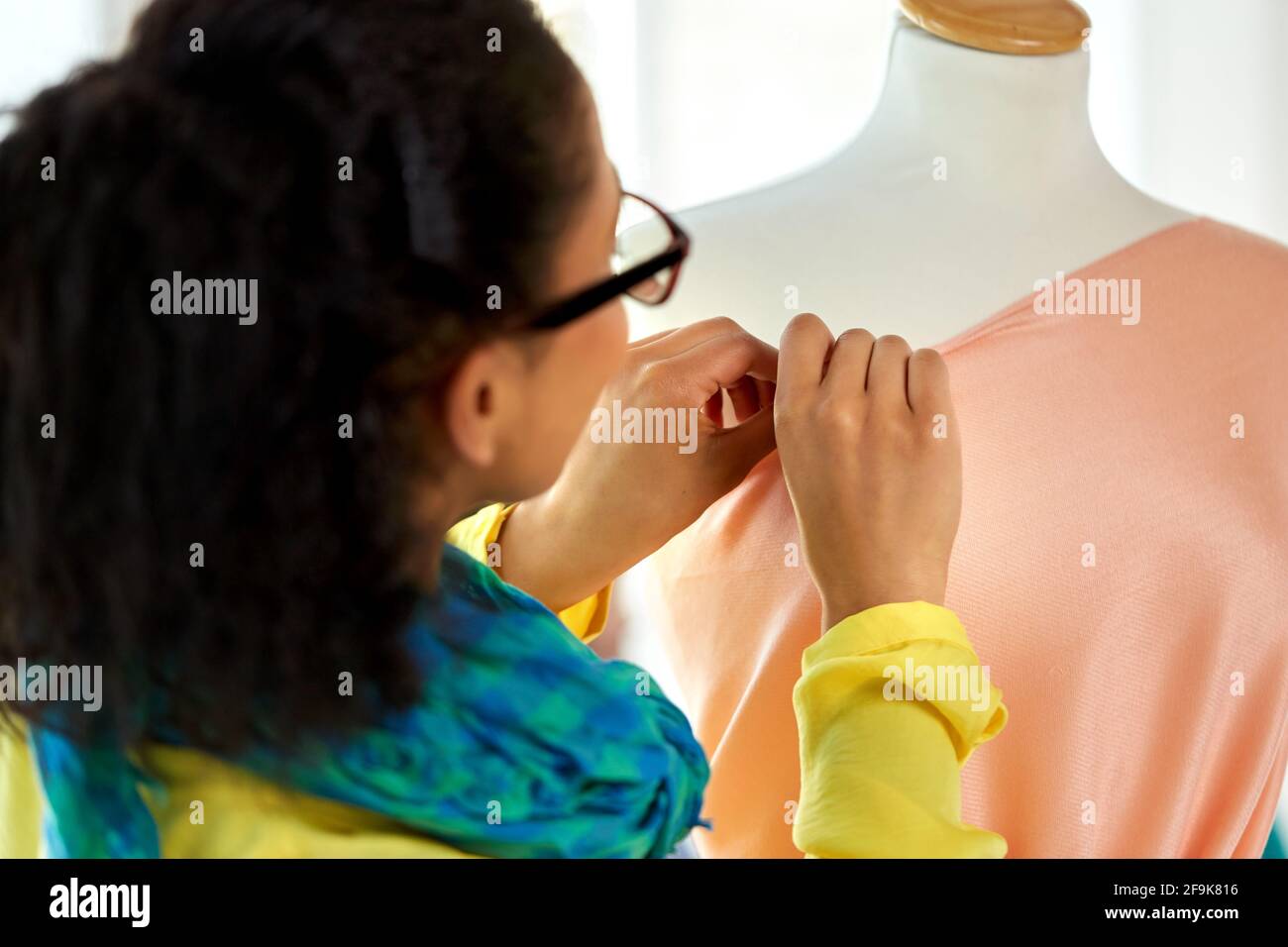 fashion designer with dummy making dress at studio Stock Photo - Alamy