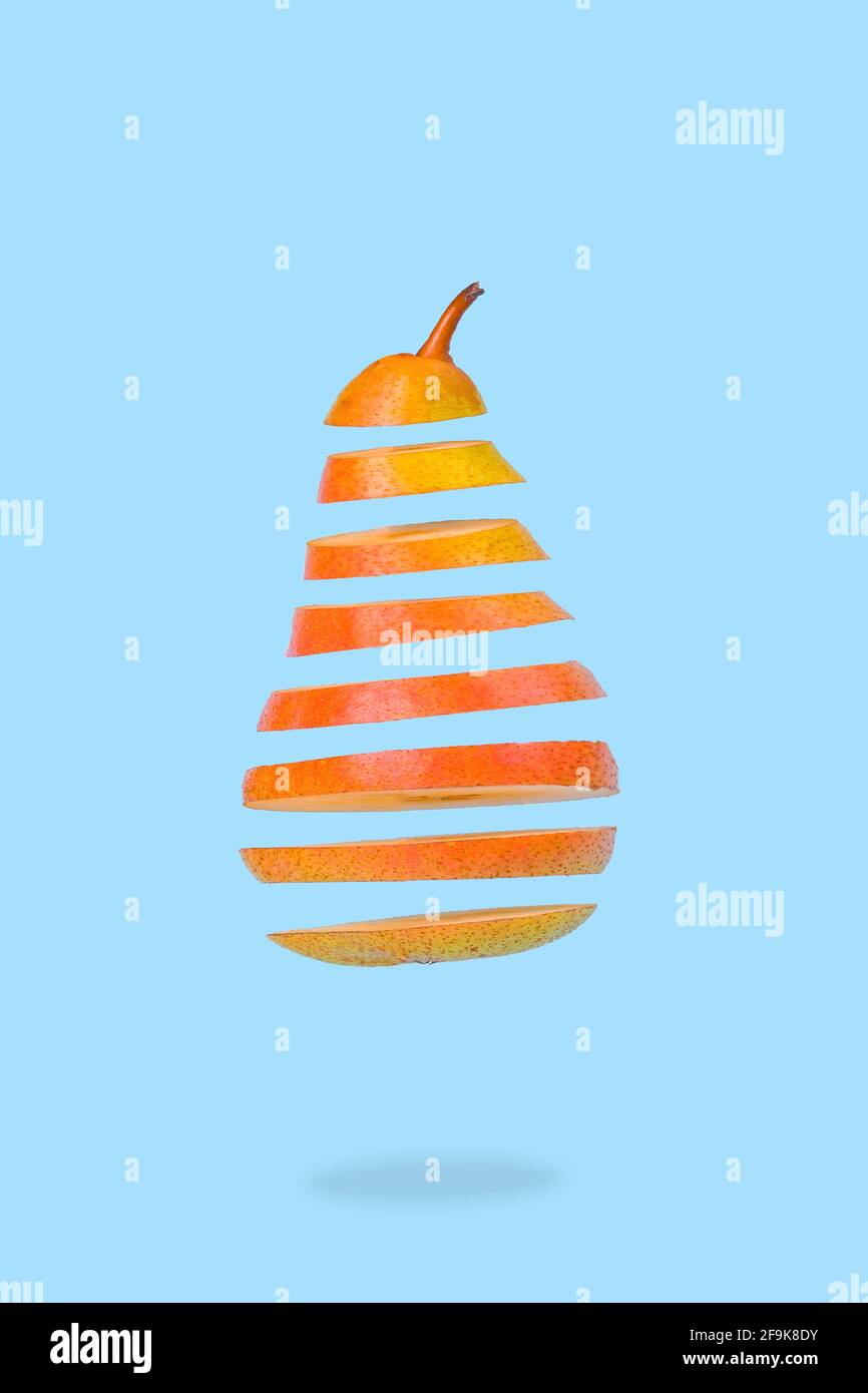 Minimal creative idea with Floating levitating ripe pear on pastel blue ...
