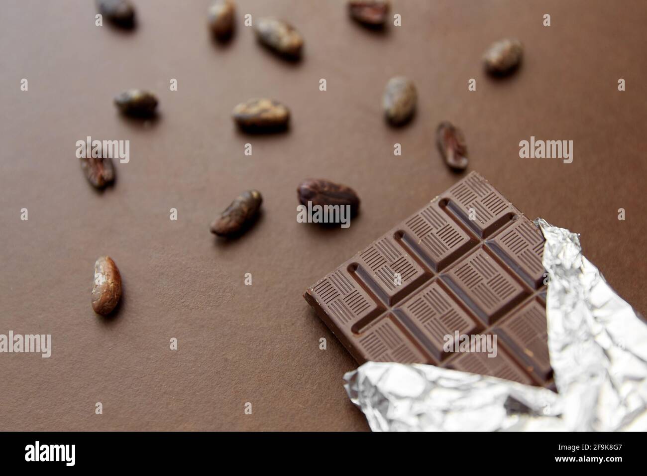 dark chocolate bar in foil wrapper and cocoa beans Stock Photo - Alamy