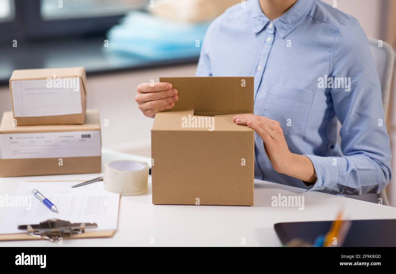 woman packing parcel box at post office Stock Photo - Alamy
