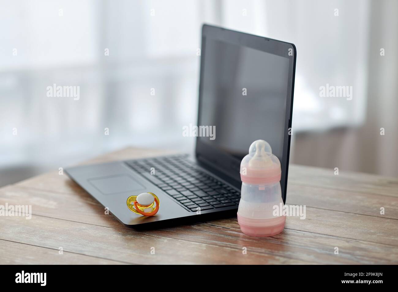 baby milk formula, laptop and soother on table Stock Photo - Alamy