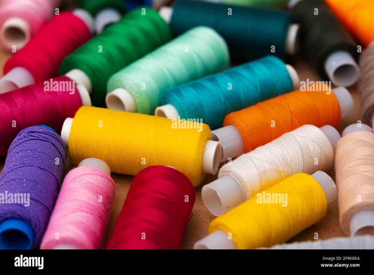 Many colored spools of threads as a background Stock Photo - Alamy