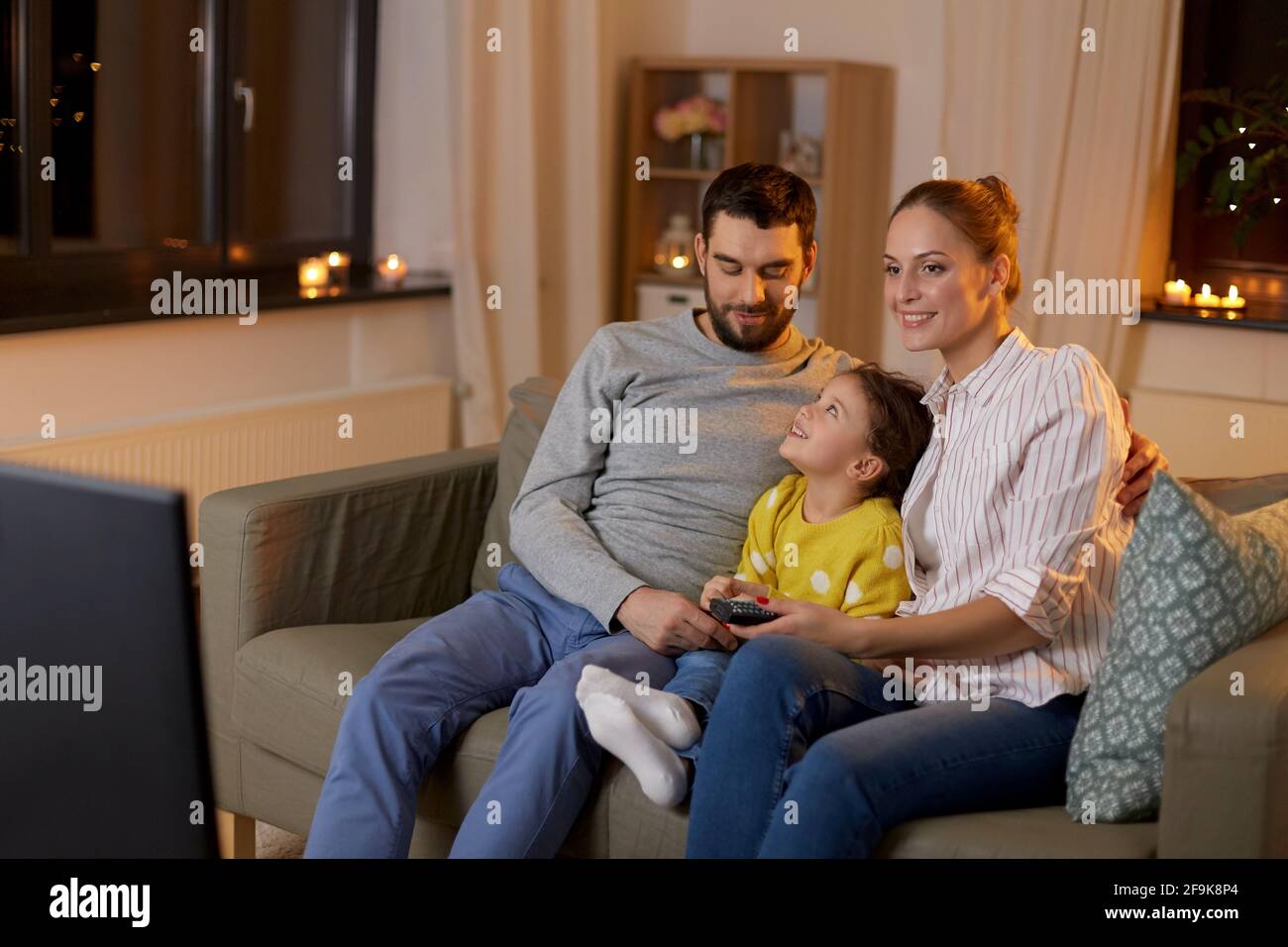 happy family watching tv at home at night Stock Photo - Alamy