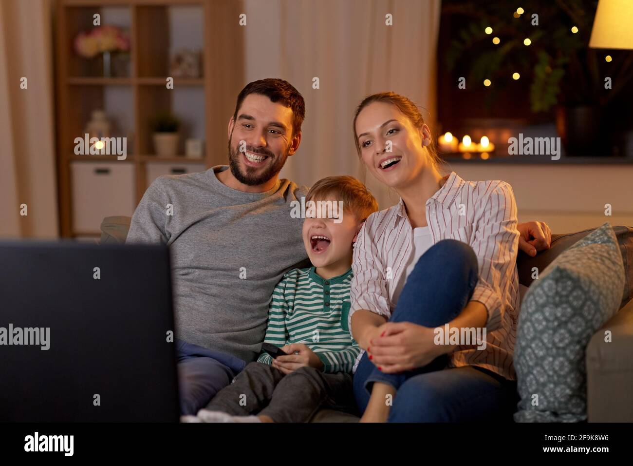 happy family watching tv at home at night Stock Photo - Alamy