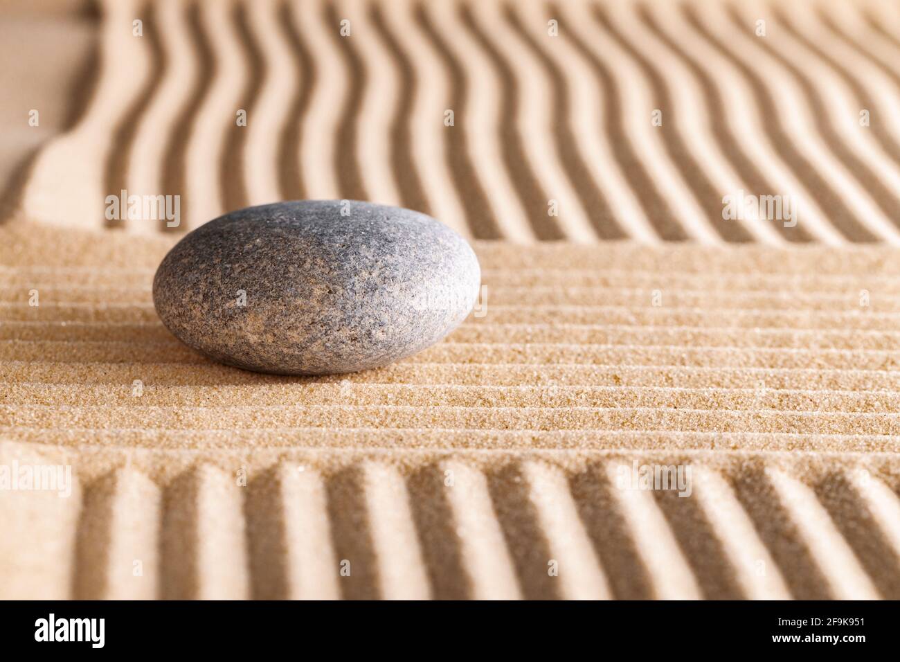 Japanese zen garden with stone in raked sand Stock Photo - Alamy