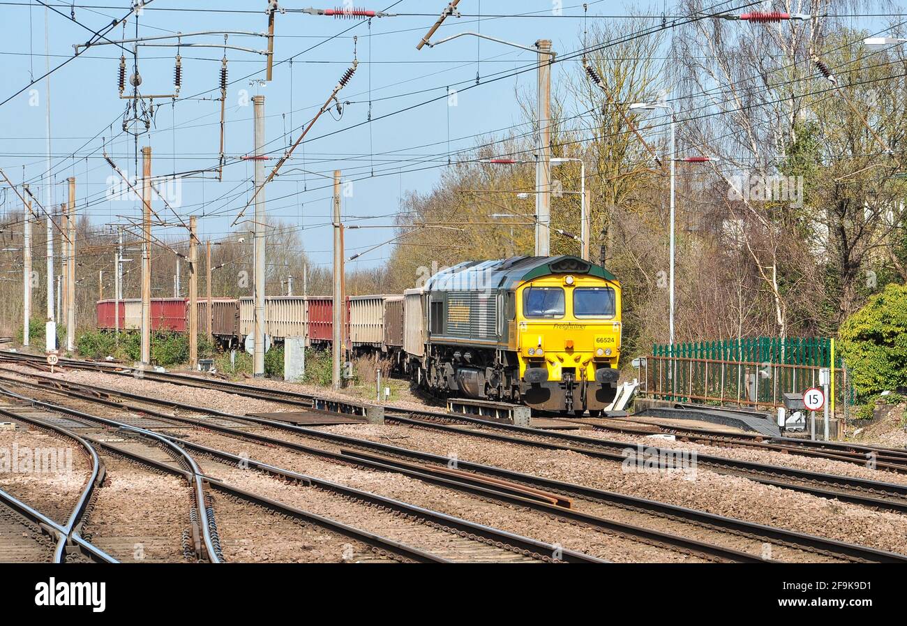 Freightliner class 66 diesel locomotive waits with stone wagons in a ...