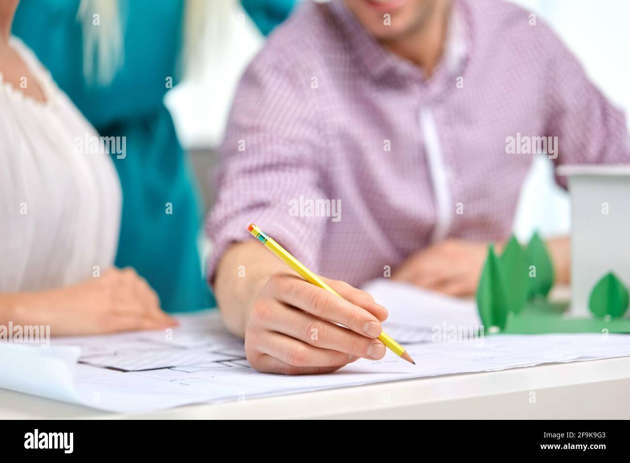 creative team building project blueprint at office Stock Photo - Alamy