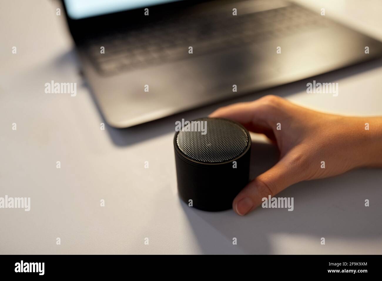 hand using smart speaker at night office Stock Photo - Alamy
