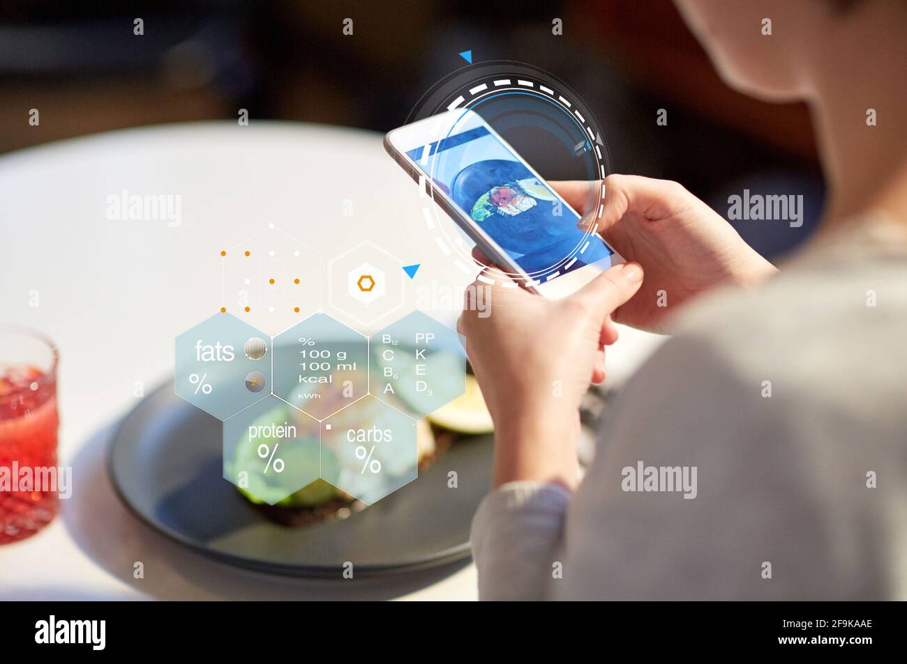 hands with phone and food nutritional value chart Stock Photo - Alamy