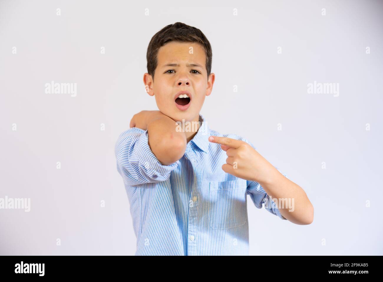 Little kid with painful gesture isolated over white background Stock ...