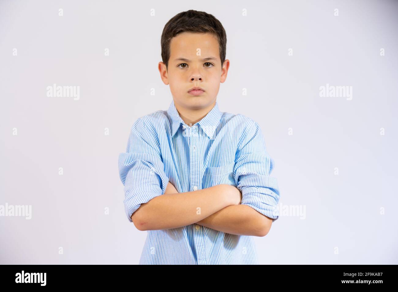 Little boy with arms folded isolated over white background Stock Photo ...