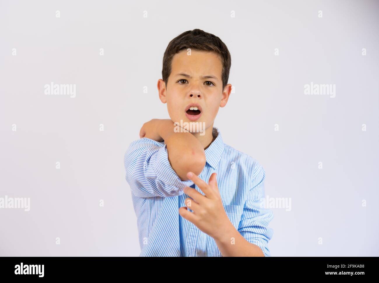 Little kid with painful gesture isolated over white background Stock ...