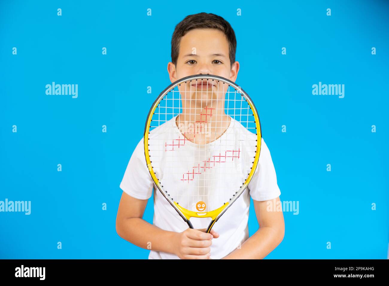 Young boy with tennis racket and ball Stock Photo - Alamy