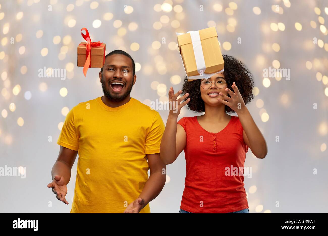 happy african american couple throwing gift boxes Stock Photo - Alamy