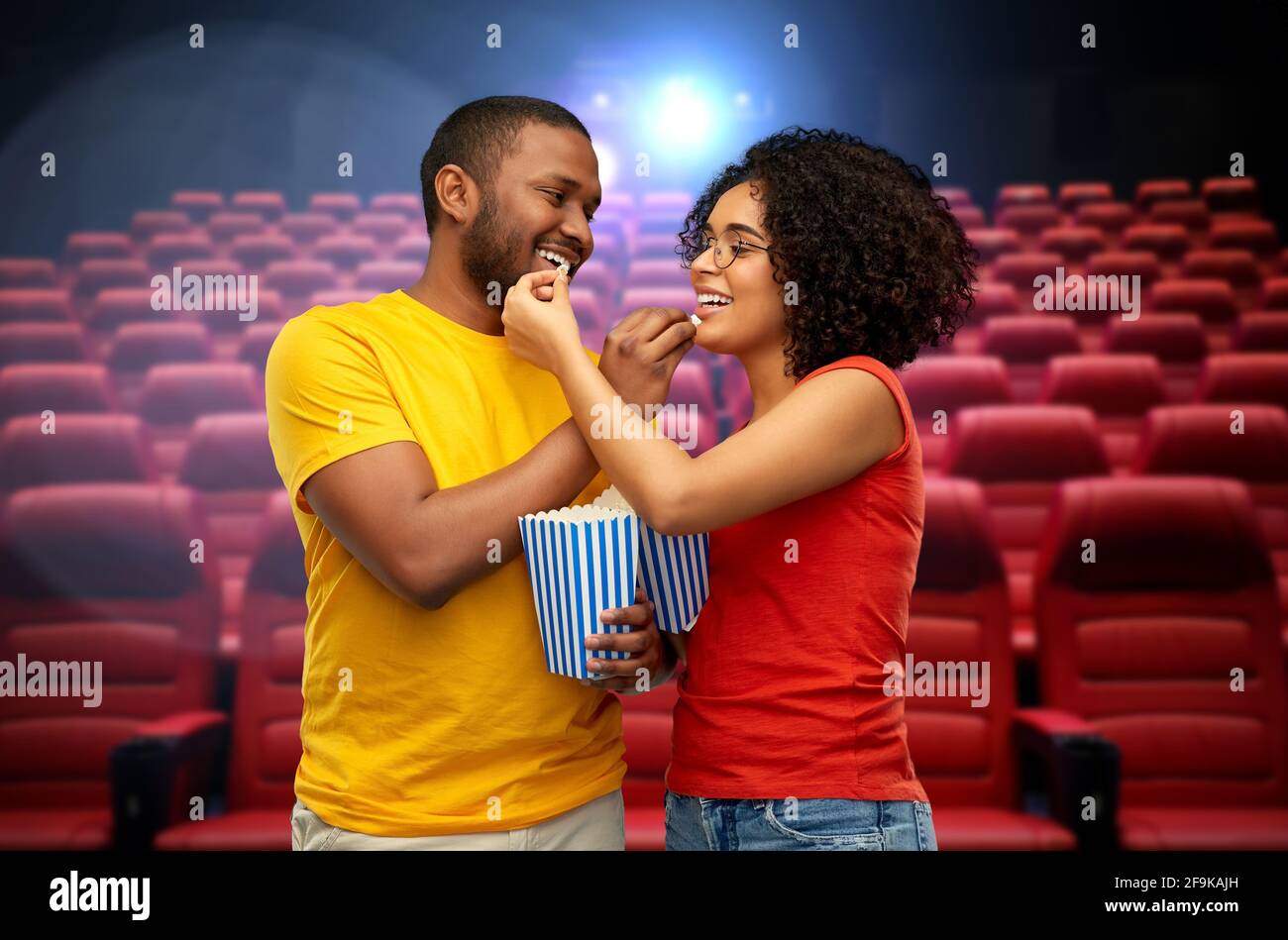 happy african american couple eating popcorn Stock Photo - Alamy