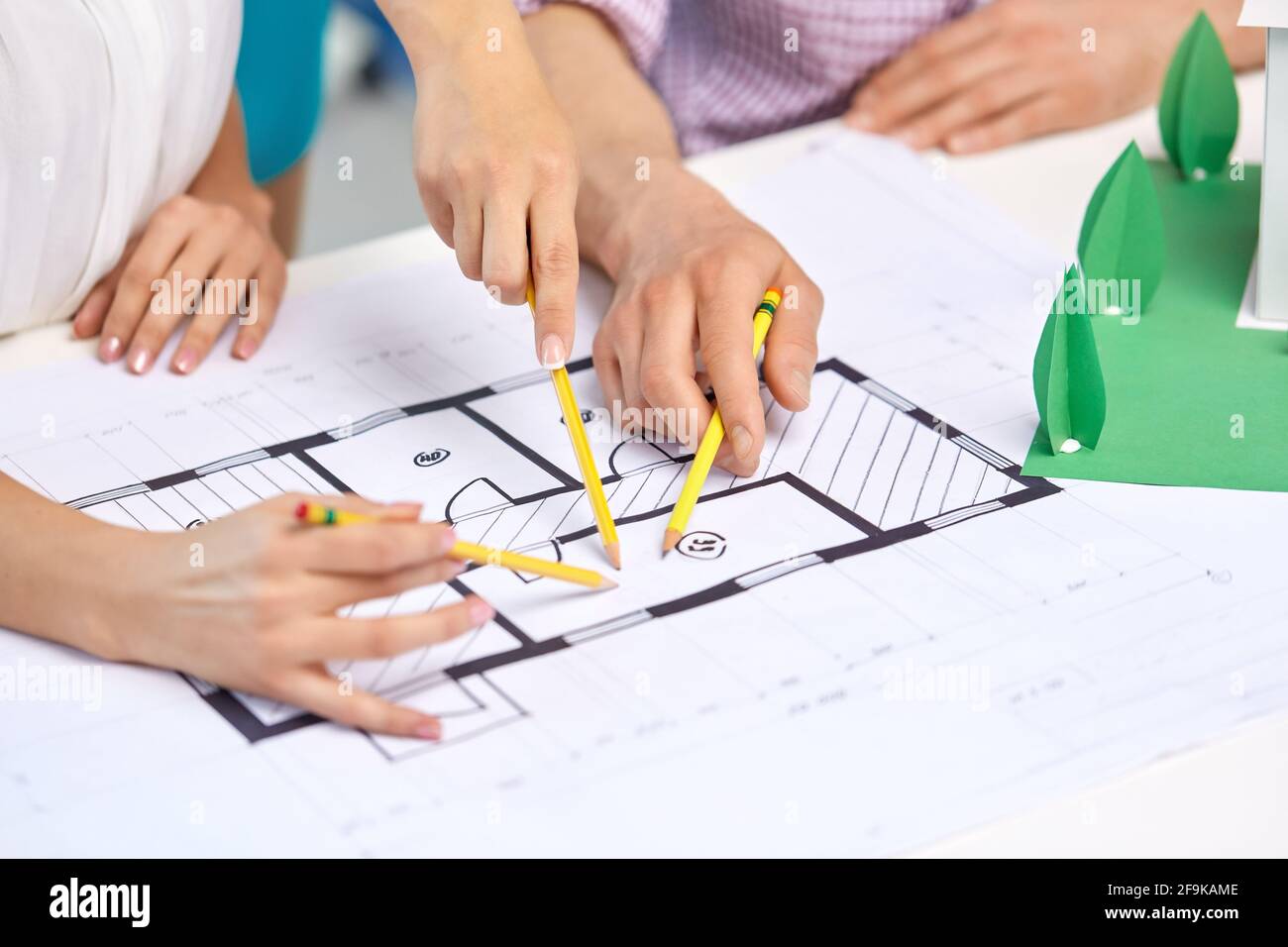 creative team building project blueprint at office Stock Photo - Alamy