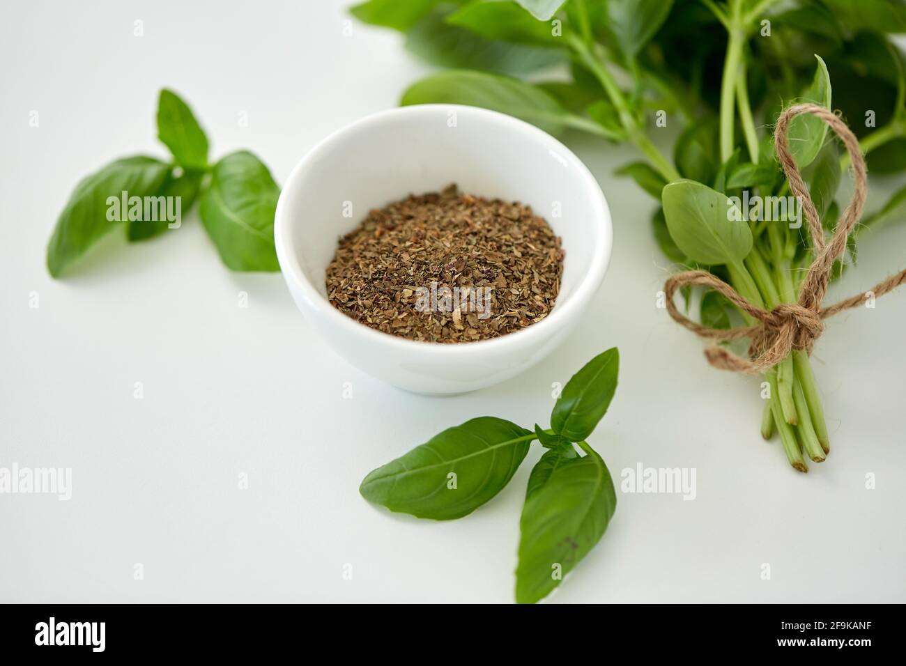 fresh basil and dry seasoning on white background Stock Photo - Alamy