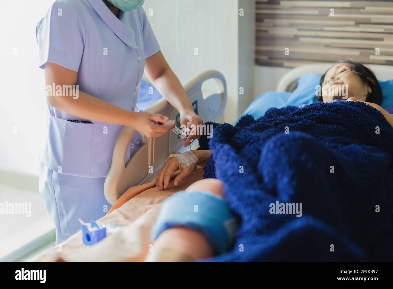 Nurse giving an injection to a patient at the hospital Stock Photo - Alamy