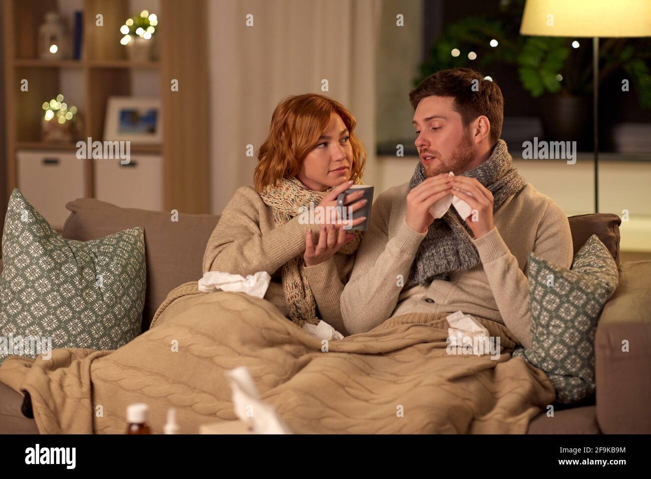 sick young couple drinking hot tea at home Stock Photo - Alamy
