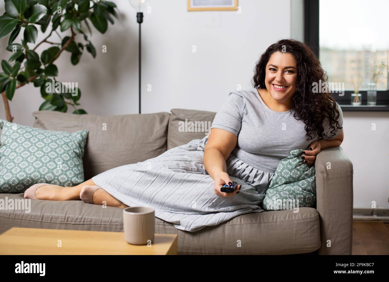 Woman remote control hi-res stock photography and images - Alamy