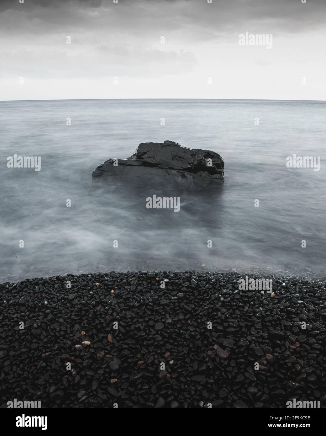 Beach with black rocks hi-res stock photography and images - Alamy