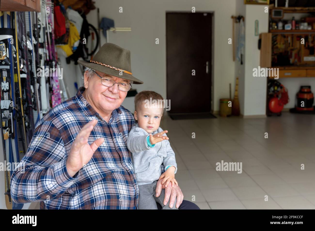 Happy senior caucasian old male person portrait sitting at home garage ...