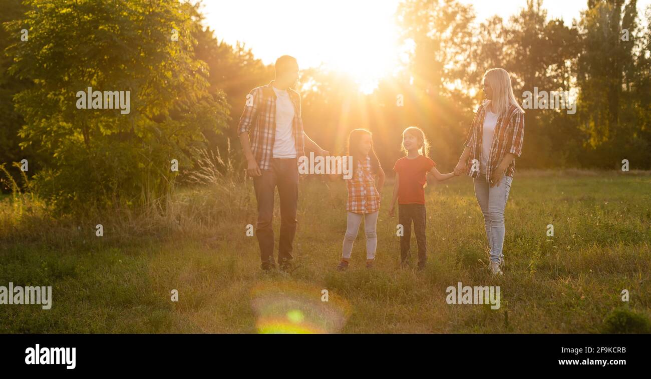 Happy family: mother father and child daughter on nature on sunset ...